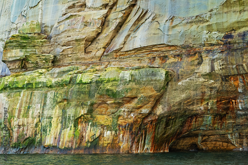 Abstract landscape of mineral stained cliff along the eroded sandstone ...