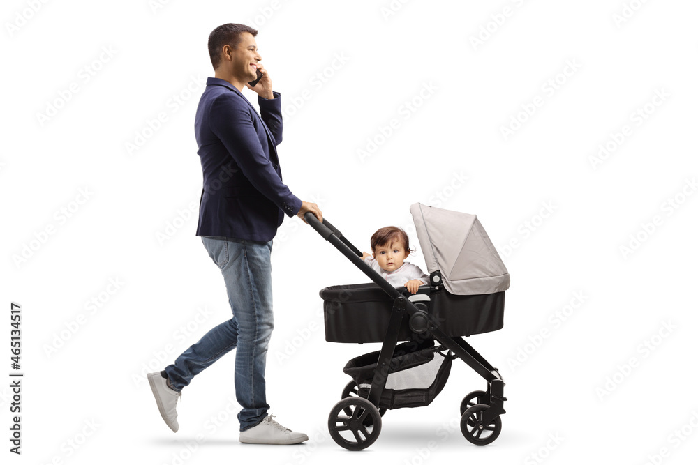 Full length profile shot of a father pushing a baby stroller and making ...