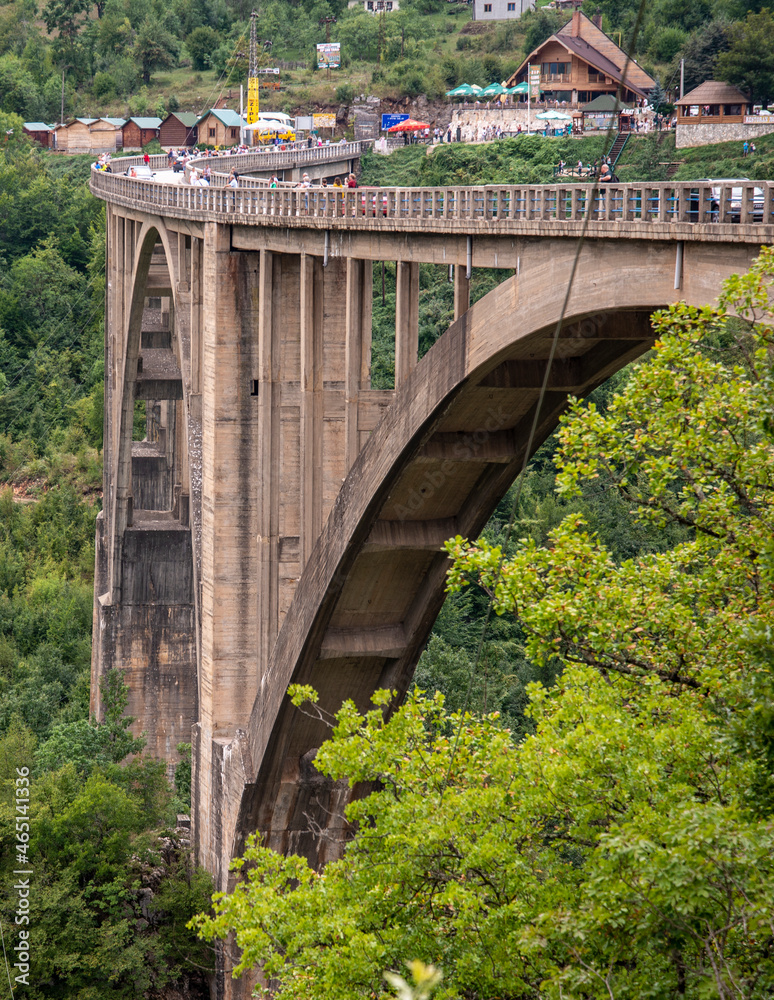 Tourists visiting Tara Bridge, crossing the high Montenegrin Canyon ...