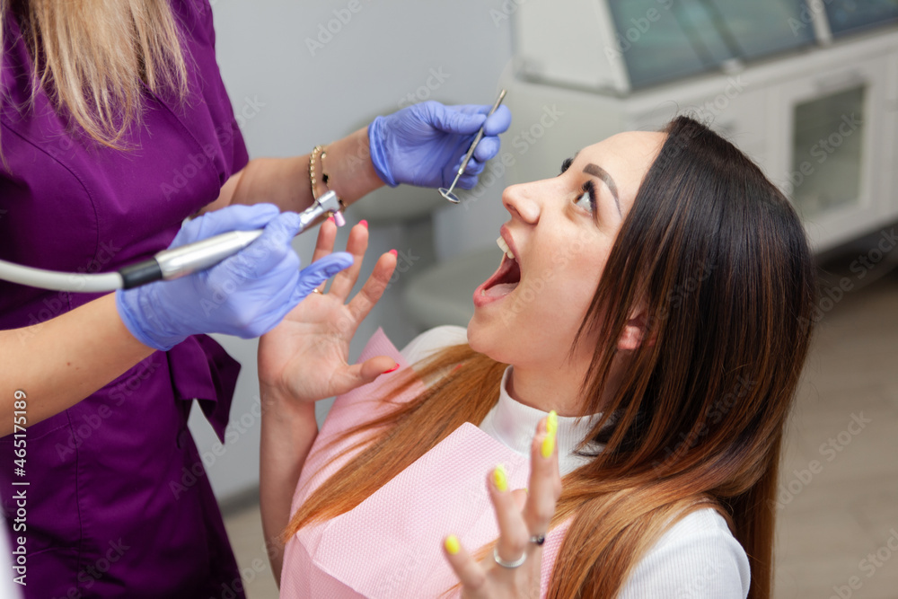 Scared screaming woman patient on examination at the dentist in the ...