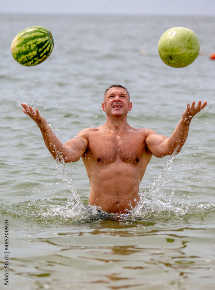 Full Length Of Shirtless Man With Ball In Water Stock Photo | Adobe Stock
