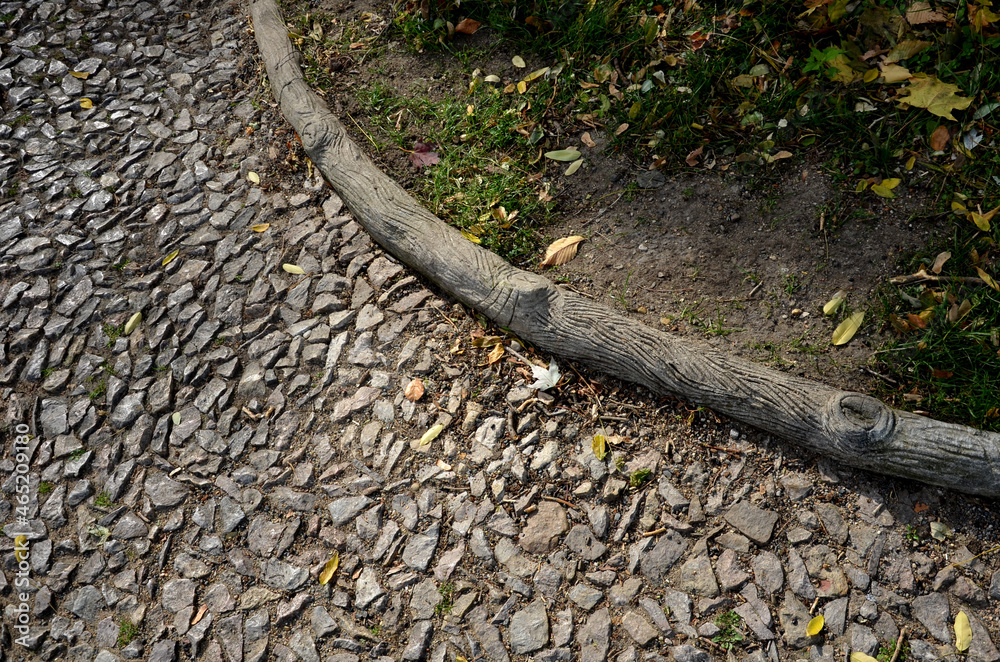 romantic garden walkway in the park. the curb is modeled from cement ...