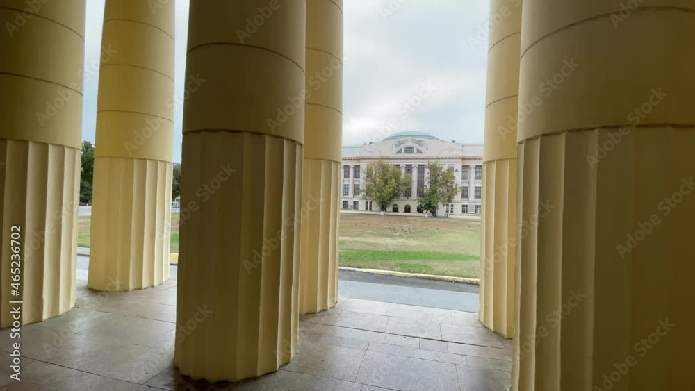 Facade of architectural building through columns. Historic house in ...