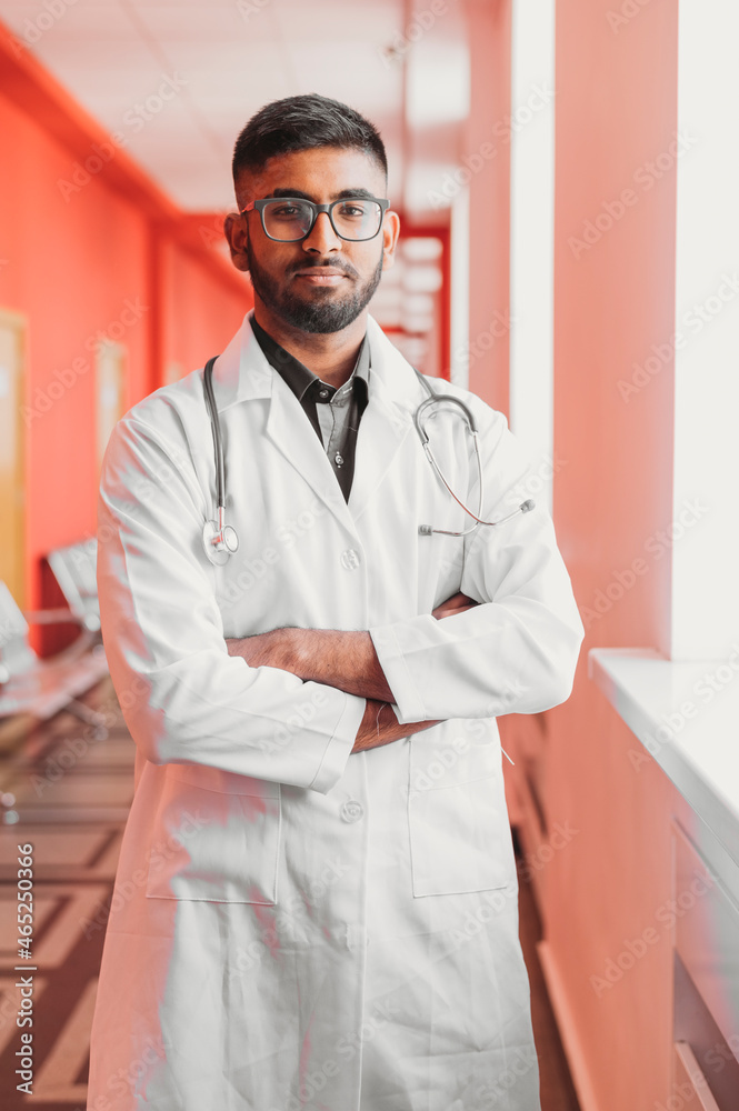 Smiling young indian medical doctor wears glasses and a stethoscope, in ...