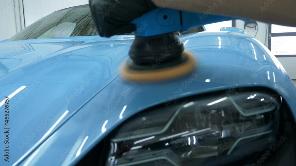 Close up to PPF installation process on a front headlight and hood. PPF ...