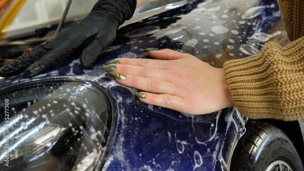 Close up to PPF installation process on a front headlight and hood. PPF ...