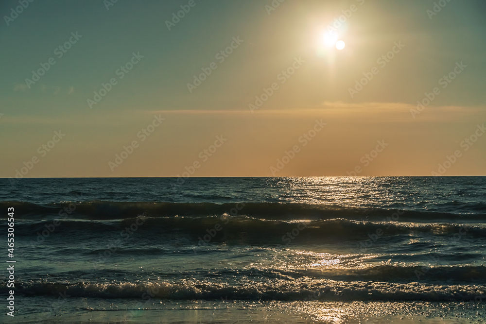 Sun, sky, sea, waves. Sun shines on the sea before sunset. Beautiful ...