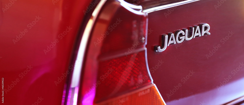 Classic Jaguar car. Red car. Logo. Mark on the trunk of the car. Close ...