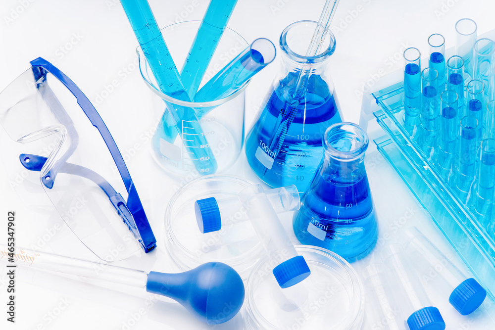 Collection of medical flasks on a blue background.Science glass flask ...
