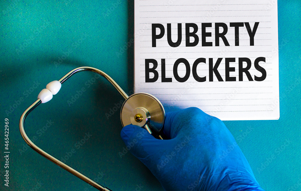 Medical and puberty blockers symbol. Words 'puberty blockers' on white ...