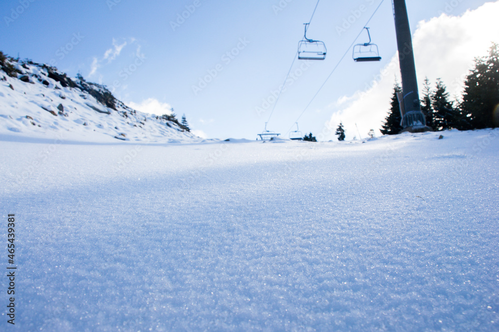 snow-themed background with ski resort and cable car on the mountain ...