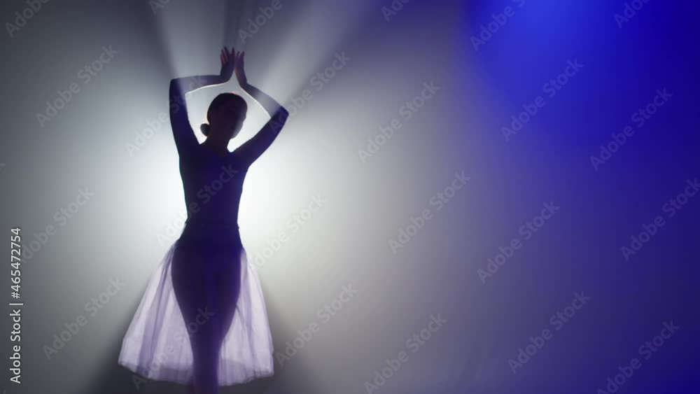 Ballerina dancing on blue background. Beautiful woman showing ballet ...