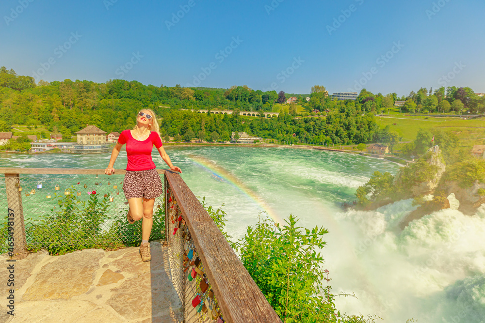 Girl with rainbow. Aerial view of Swiss waterfall Rhine Falls in ...
