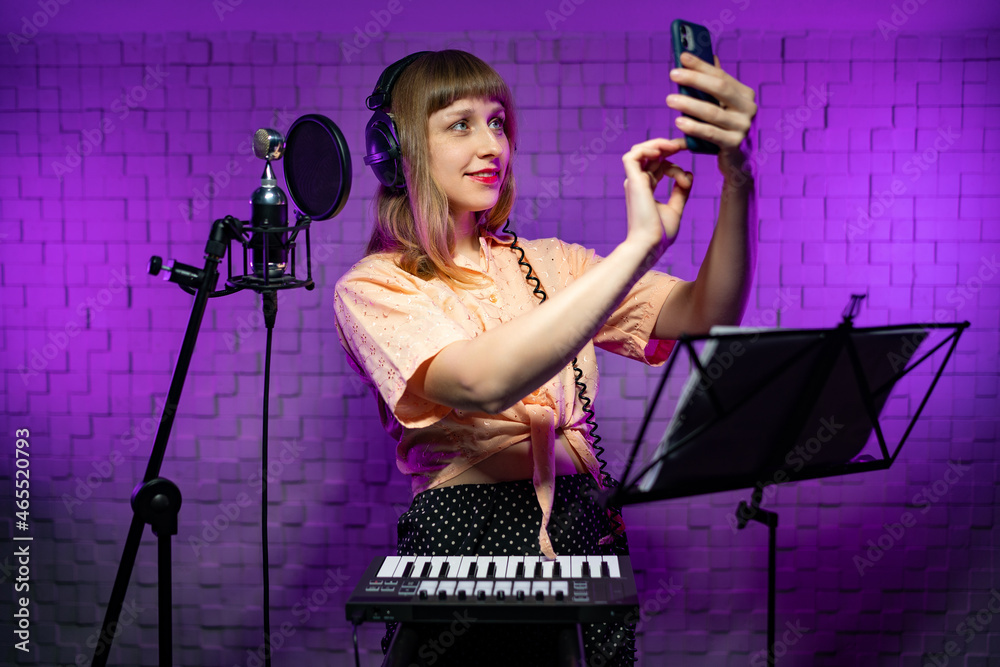 middle aged caucasian woman singer in studio headphones in a room with ...