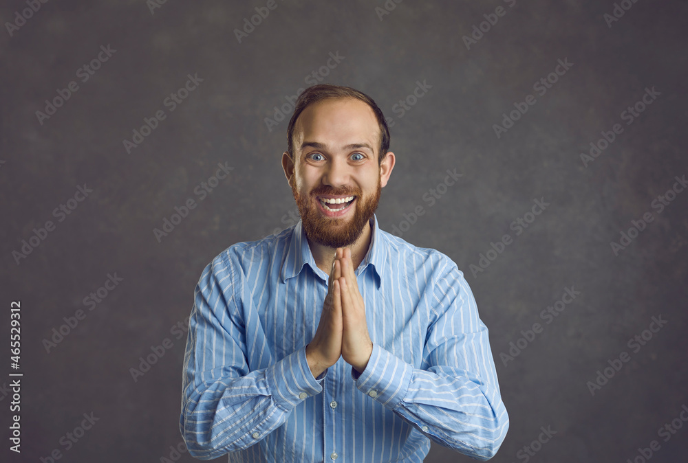 Emotional happy adult man joyfully claps his hands in a sign of finally ...