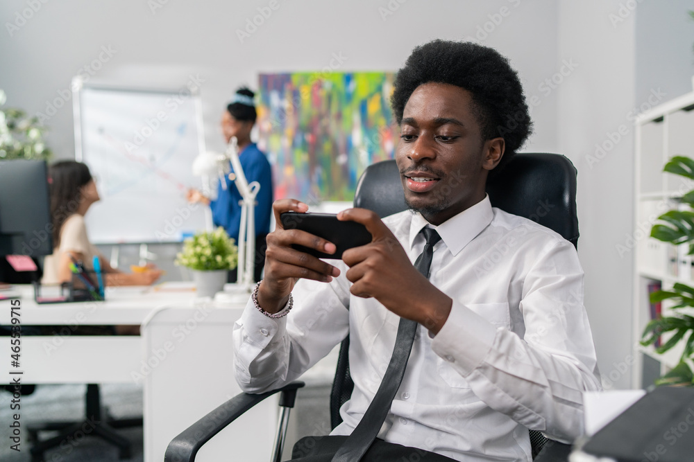 Lazy employee with afro and dark skin sits comfortably leaning on a ...