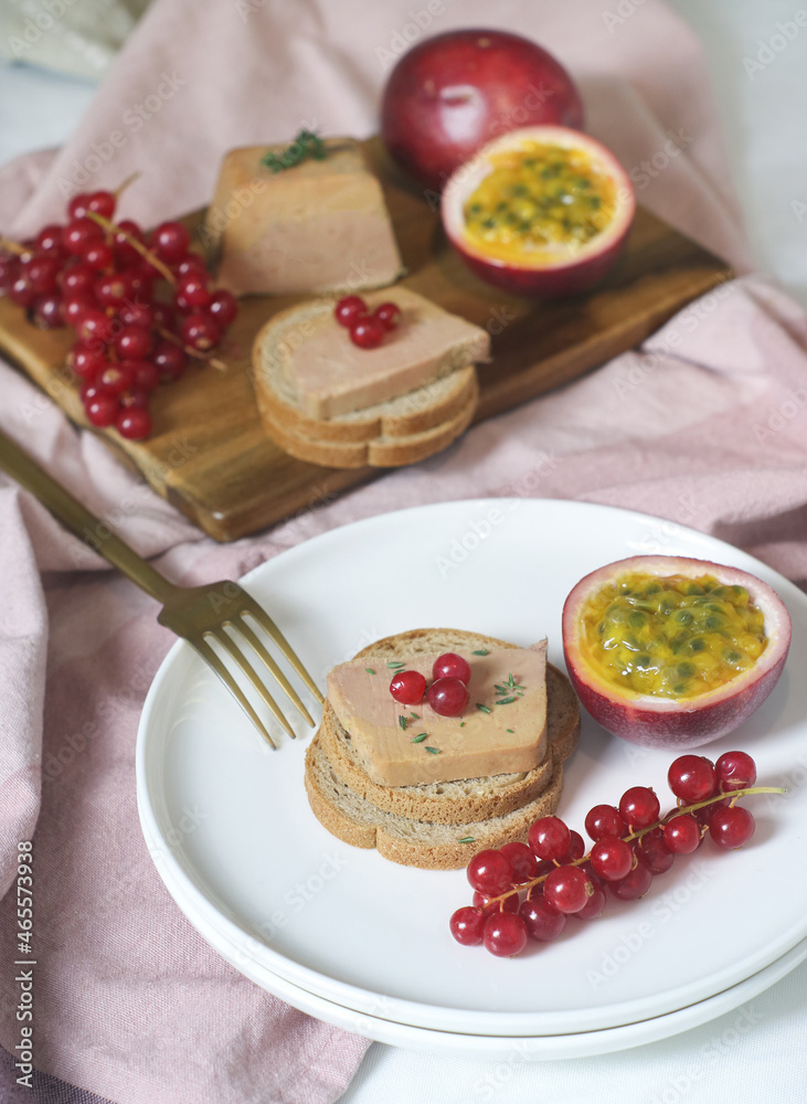 Tradtional French foie gras and toaster bread in a white plate with ...