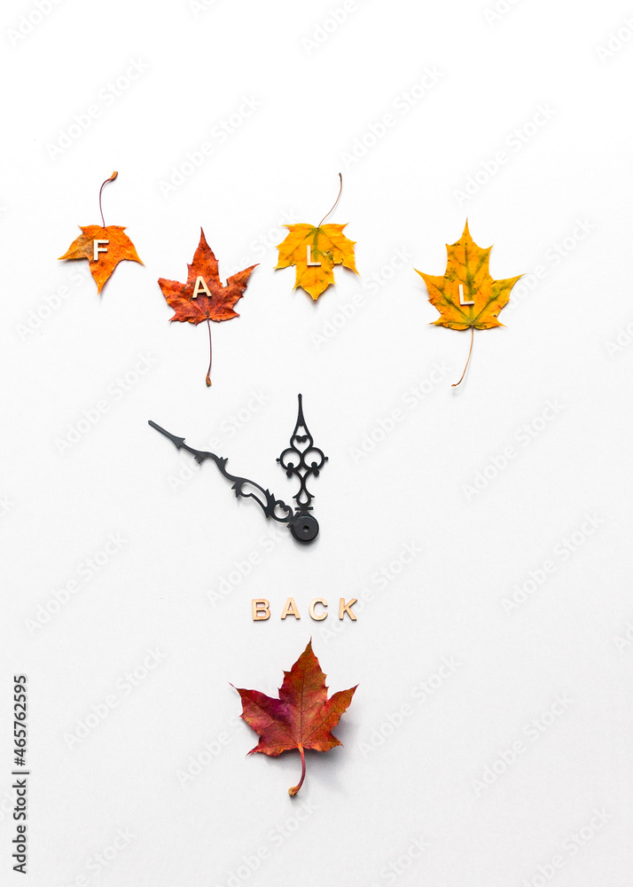 Fall back. Daylight saving time concept. Clock hands and yellow red ...
