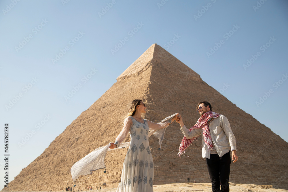 traveling couple dancing at pyramids of giza Stock Photo | Adobe Stock