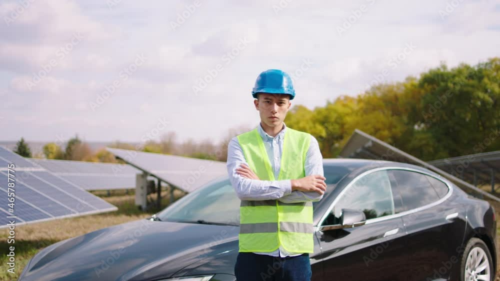 At solar panels power station posing in front of the camera ecological ...