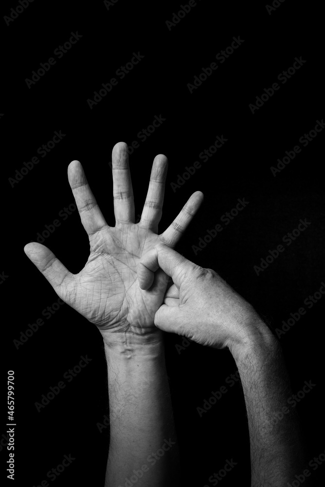B+W image of hand demonstrating BSL sign language letter R isolated ...