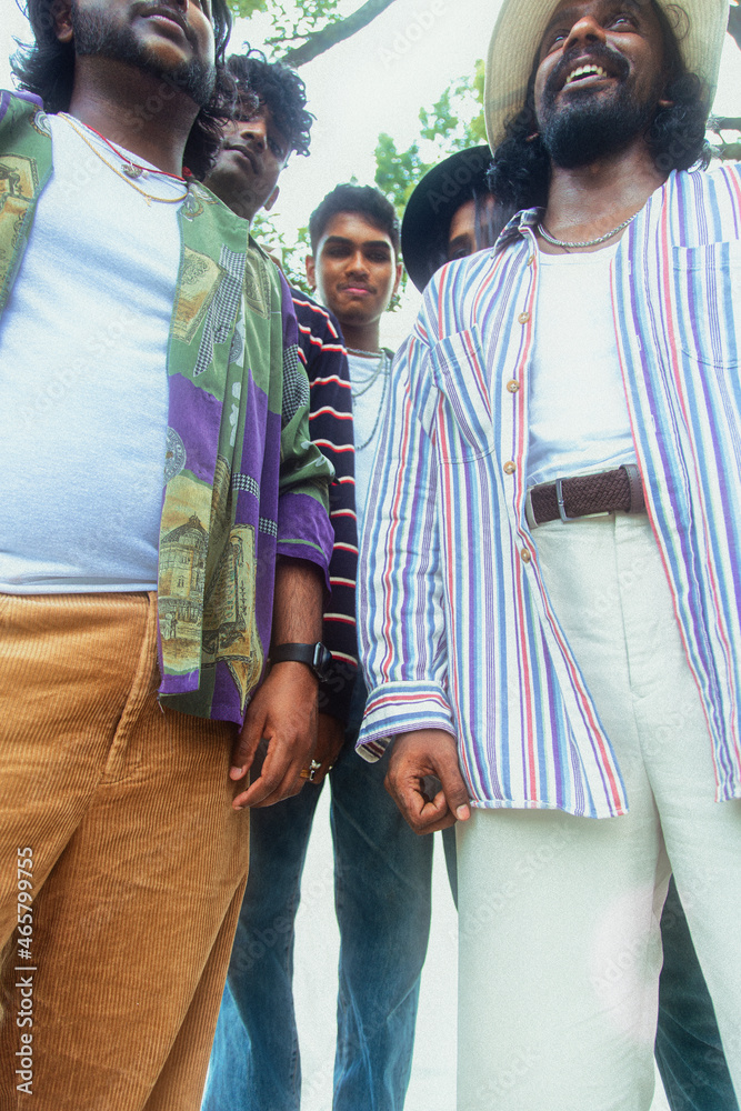 Malaysian Indian men posing and laughing together in a group setting ...
