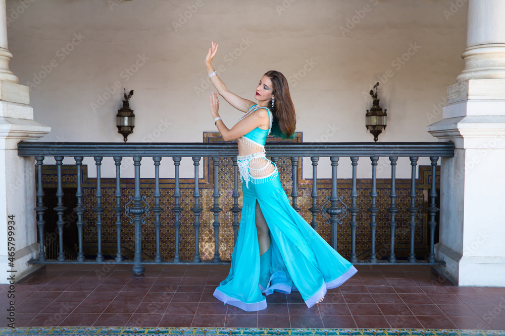 beautiful young belly dancer is posing for the camera in a photo shoot ...