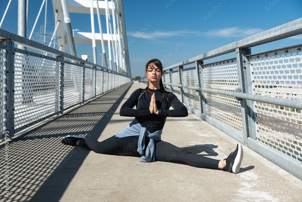 Young strong active fitness woman, in sportswear, doing yoga exercises ...