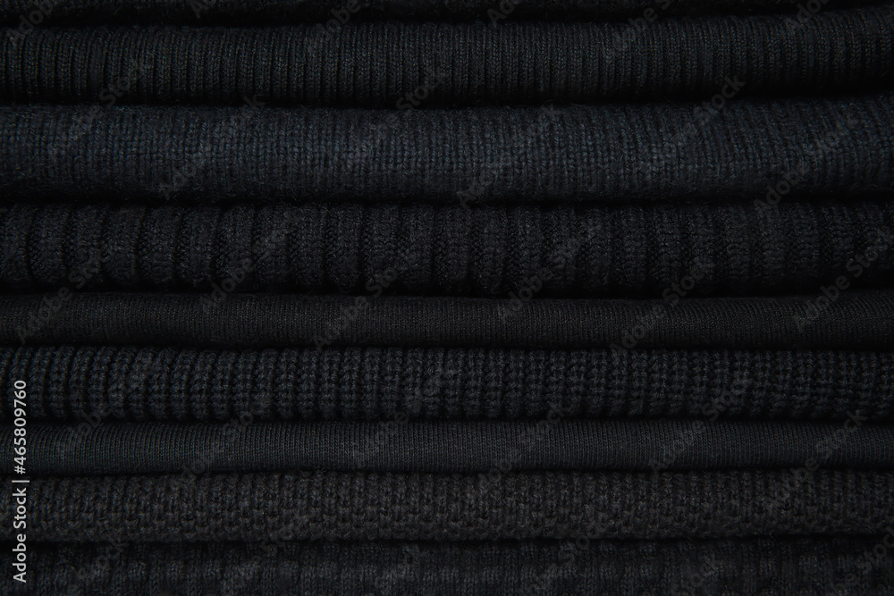 A stack of black things, clothes of different textures. Fabric texture ...
