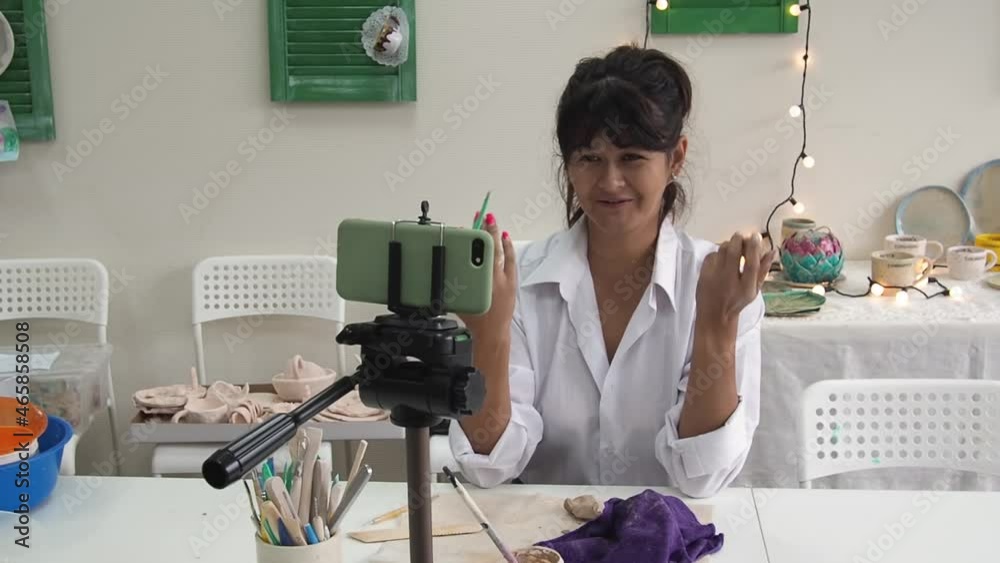 Woman pottery tutor in art studio record video lesson for ceramict ...