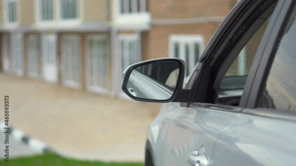 woman arm driver drank coffee and threw glass out window. Silver car in ...