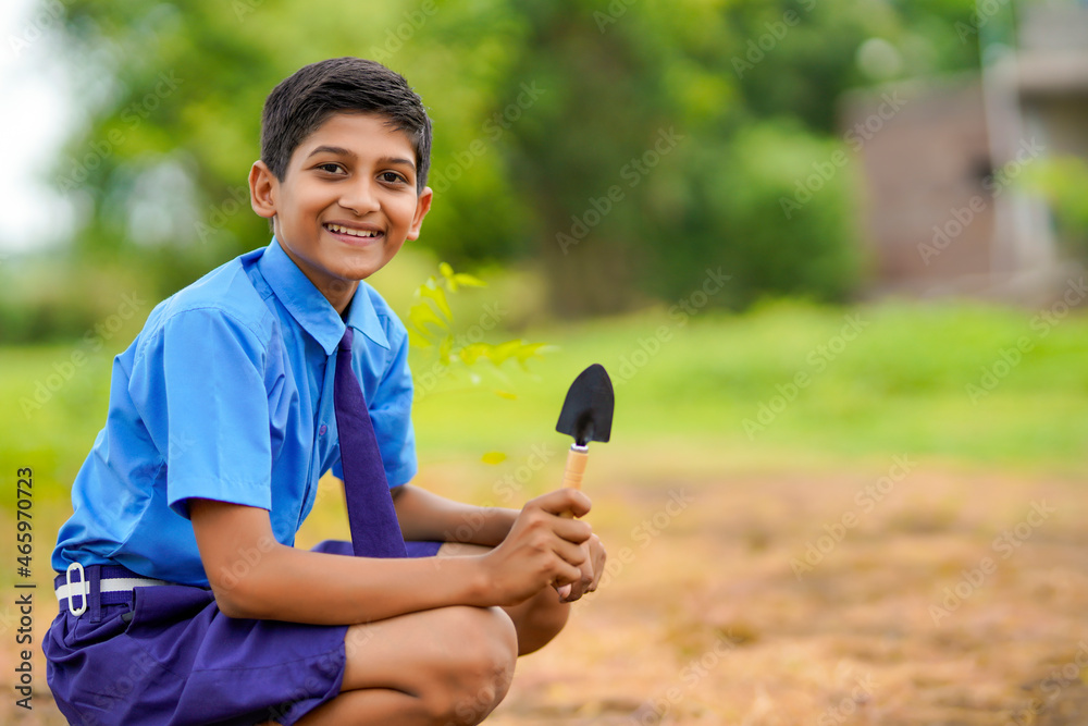 Indian school child doing tree plantation. Stock Photo | Adobe Stock