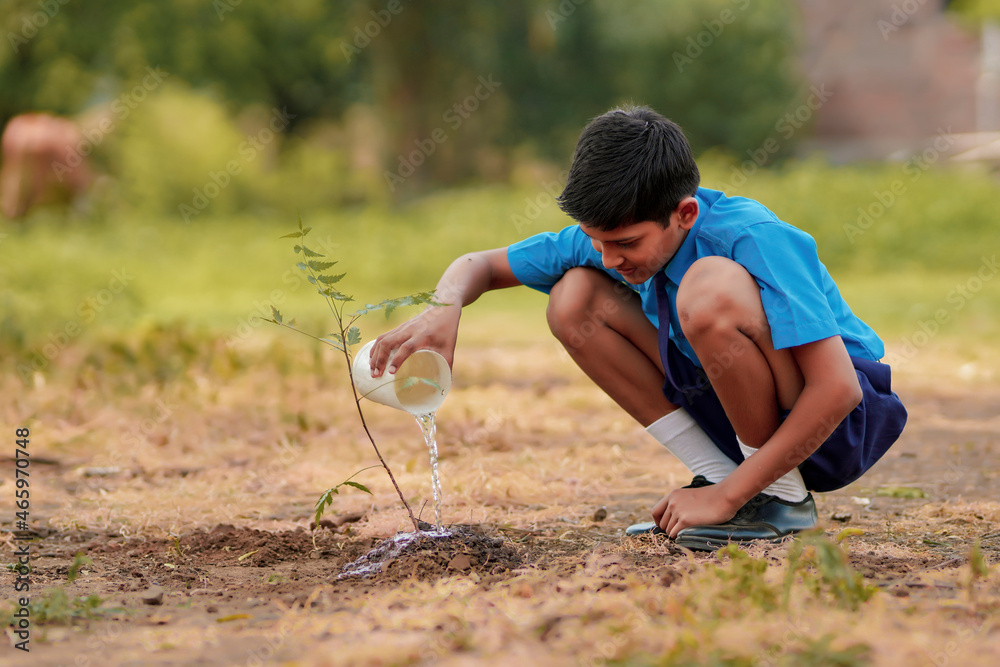 Indian school child doing tree plantation. Stock Photo | Adobe Stock