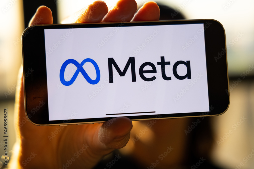 Meta logo on the iPhone. Woman holding smartphone with new facebook ...