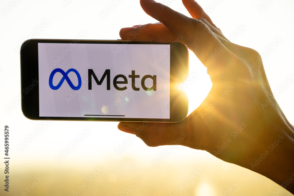 Meta logo on the iPhone. Woman holding smartphone with new facebook ...