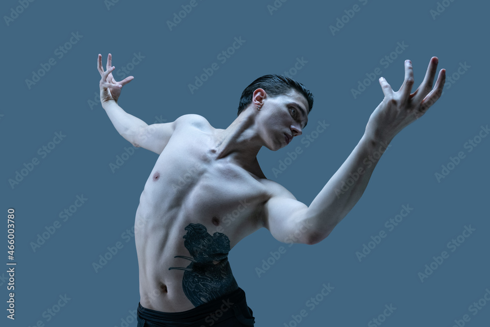 Half-length portrait of young man, flexible male contemp dancer dancing ...