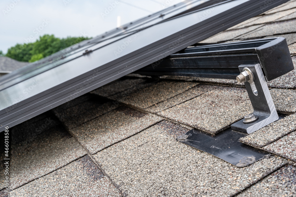 Rail, bracket, and anchor to a solar panel installed on a asphalt ...