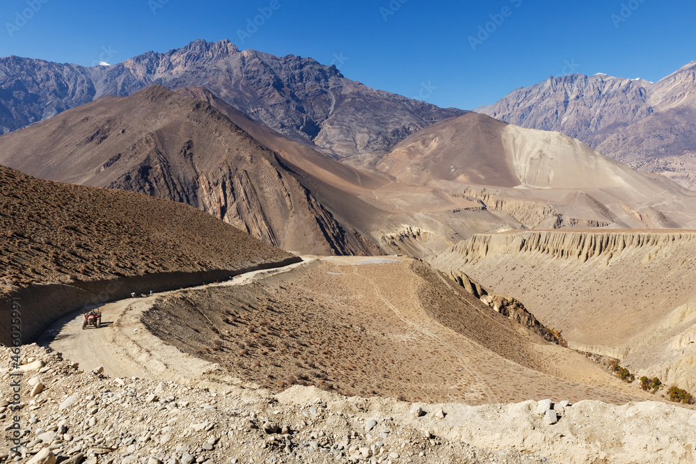 Muktinath Sadak. tractor is driving along the road in the mountains ...