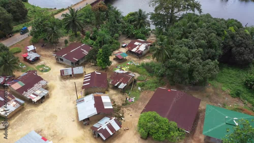 Aerial rural village homes forest jungle river bridge Liberia. Tropical ...