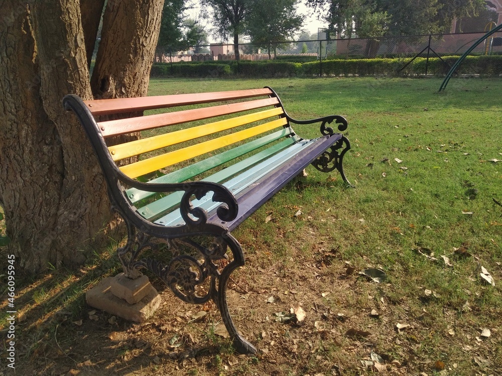 Metal rainbow color bench in a garden. Stock Photo | Adobe Stock