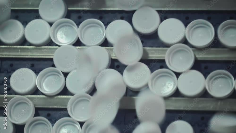 Industrial Dairy Food Manufacturing. Bottle caps are falling down on ...
