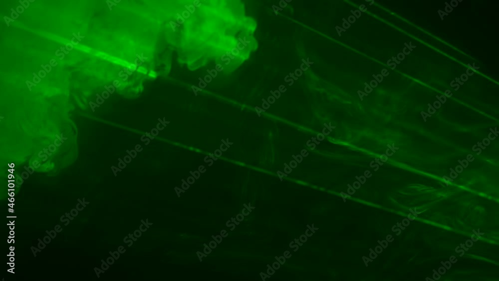 Bright beams of green neon laser light flashes and emitting lights in a ...