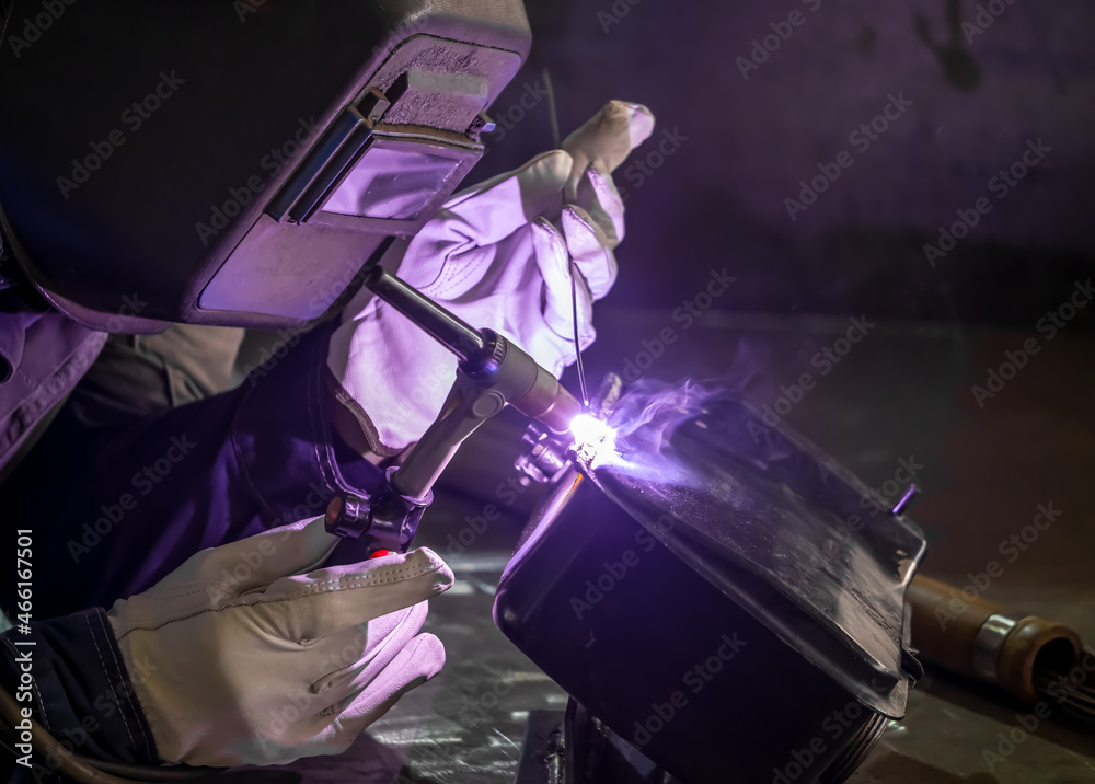 TIG welding. Welding the fuel tank of a motor pump by electric arc ...