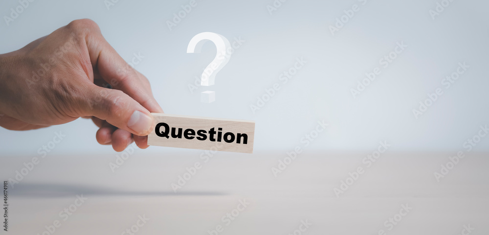 Hand hold Wooden cube block in question mark mean what on cement table ... Hand hold Wooden cube block in question mark mean what on cement table ...