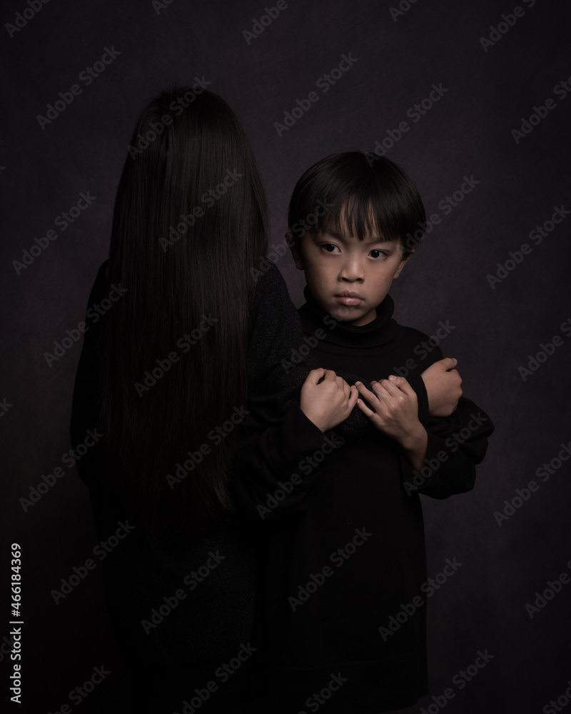 Fine art studio portait of asian brother and sister in black showing ...