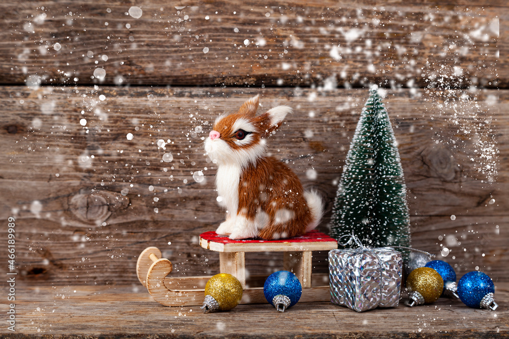 Rabbit on a sled, Christmas tree, gifts and balls Stock Photo | Adobe Stock