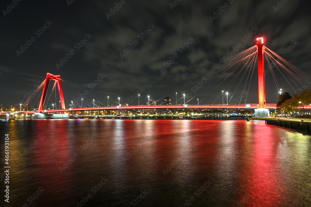 Red cable bridge in Rotterdam, Netherlands by night. Willemsbrug bridge ...