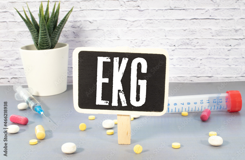 Word ECG letters stands on printed strips of examples of EKG Stock ...