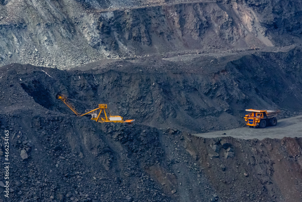 Huge empty dump truck on a gravel road in iron ore quarry Stock Photo ...