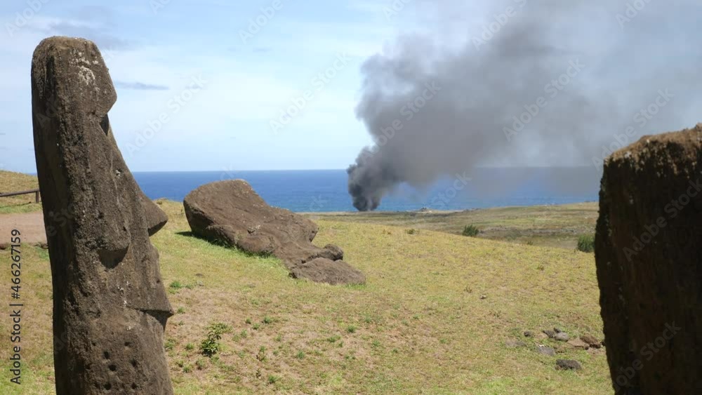 Mysterious Moai statues on fire. Ancient statues made of black volcanic ...